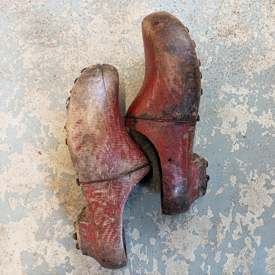 Pair of antique hand carved wooden red clogs